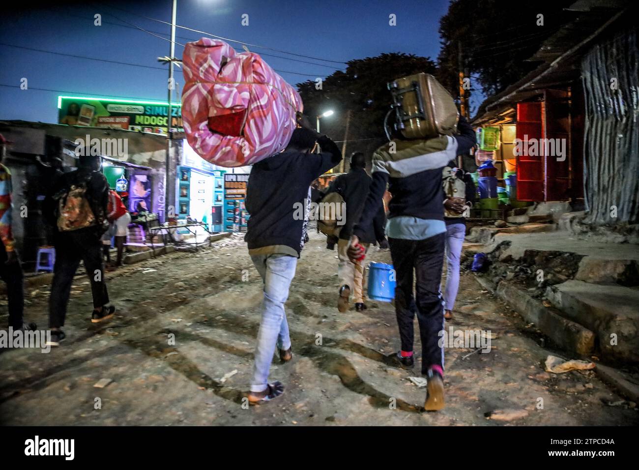 Pedestrians walk past the busy streets in Kibera Slum, Nairobi. A view ...