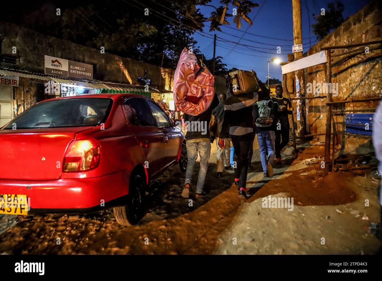 Pedestrians walk past the busy streets in Kibera Slum, Nairobi. A view ...