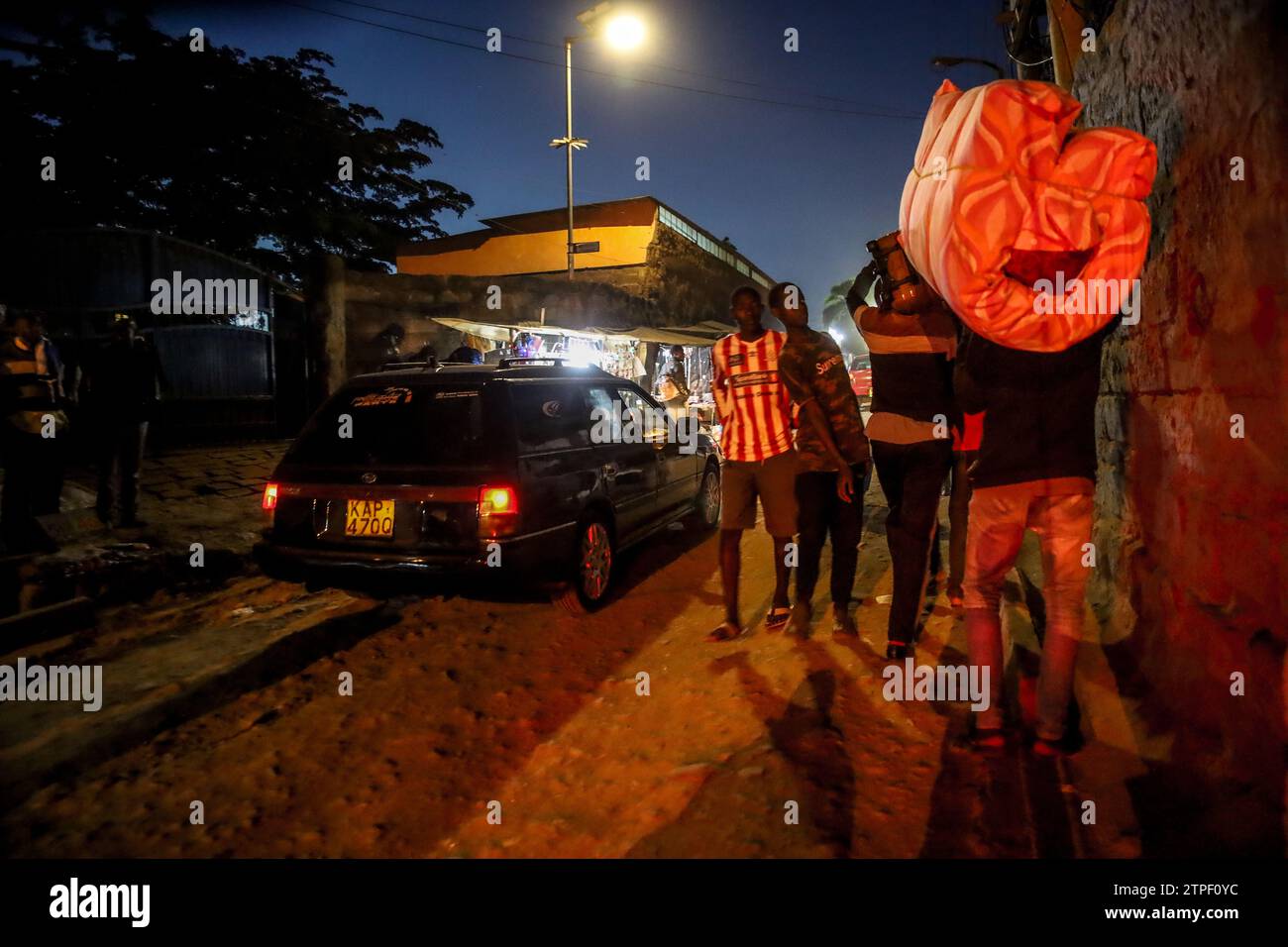 Pedestrians walk past the busy streets in Kibera Slum, Nairobi. A view ...