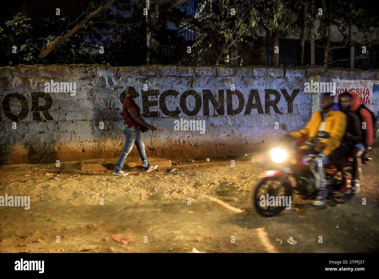 Pedestrians walk past the busy streets in Kibera Slum, Nairobi. A view ...