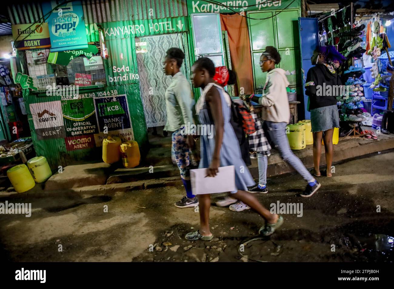 Pedestrians find their way through the busy streets in Kibera Slum ...