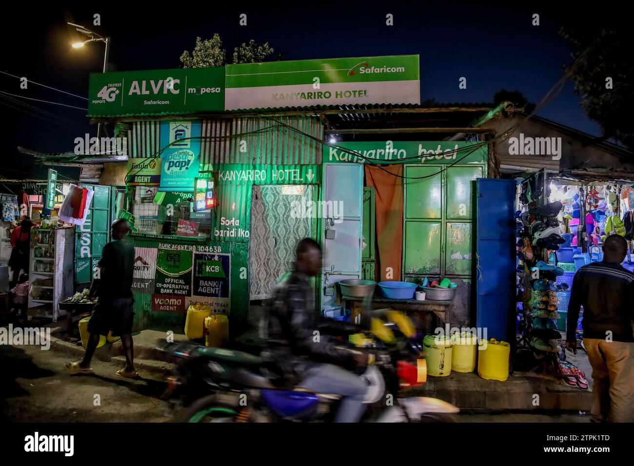 Pedestrians find their way through the busy streets in Kibera Slum ...