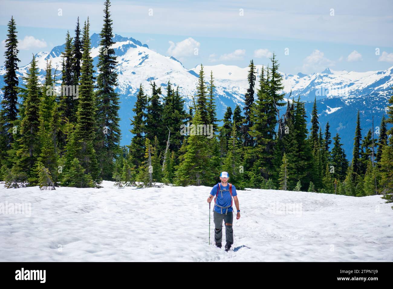 A hiker follows the snowy Panorama Ridge Trail, with the stunning ...