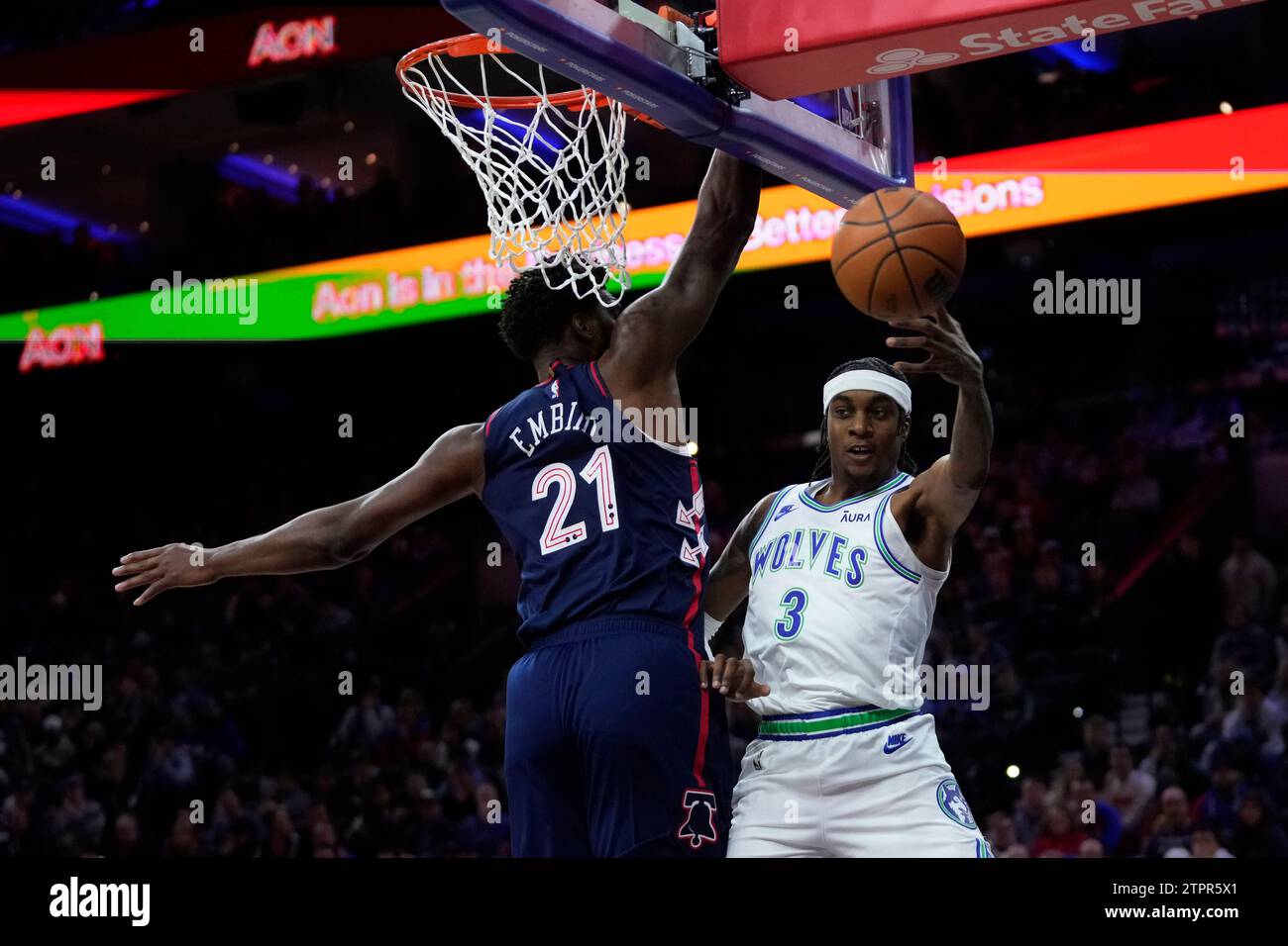 Minnesota Timberwolves' Jaden McDaniels, right, passes the ball around ...