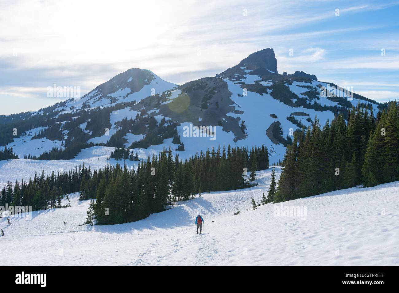 Traversing the snowy Panorama Ridge Trail, a hiker approaches the ...