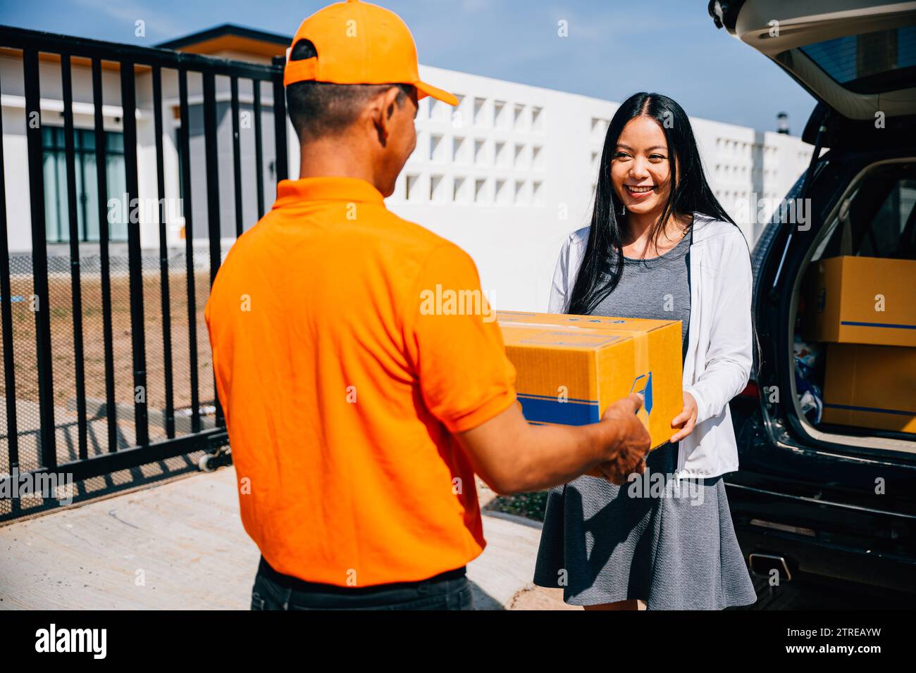 Efficient home delivery logistics depicted as a courier delivers a ...