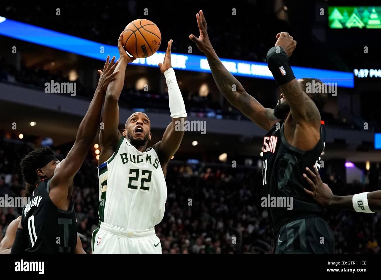 Milwaukee Bucks' Khris Middleton (22) shoots between Houston Rockets ...