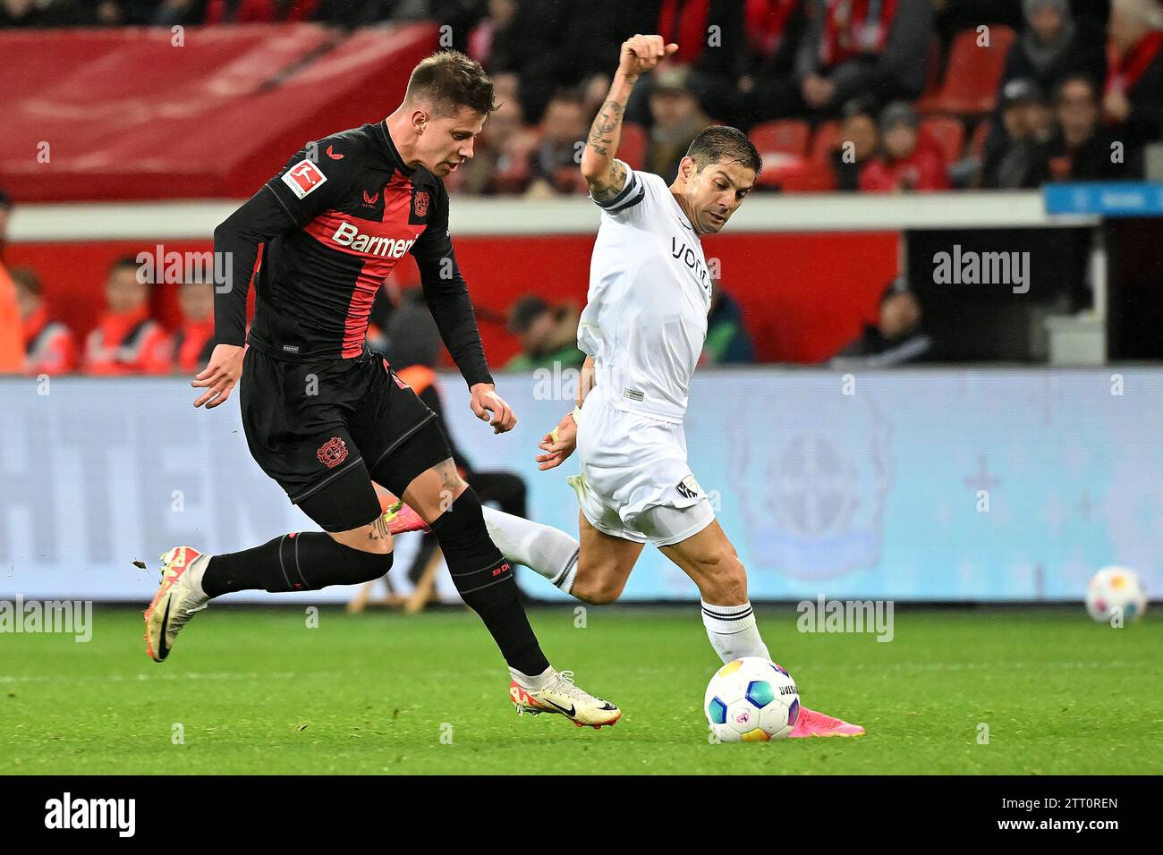Leverkusen, Germany. 20th Dec, 2023. Adam Hlozek (L) of Bayer 04 ...