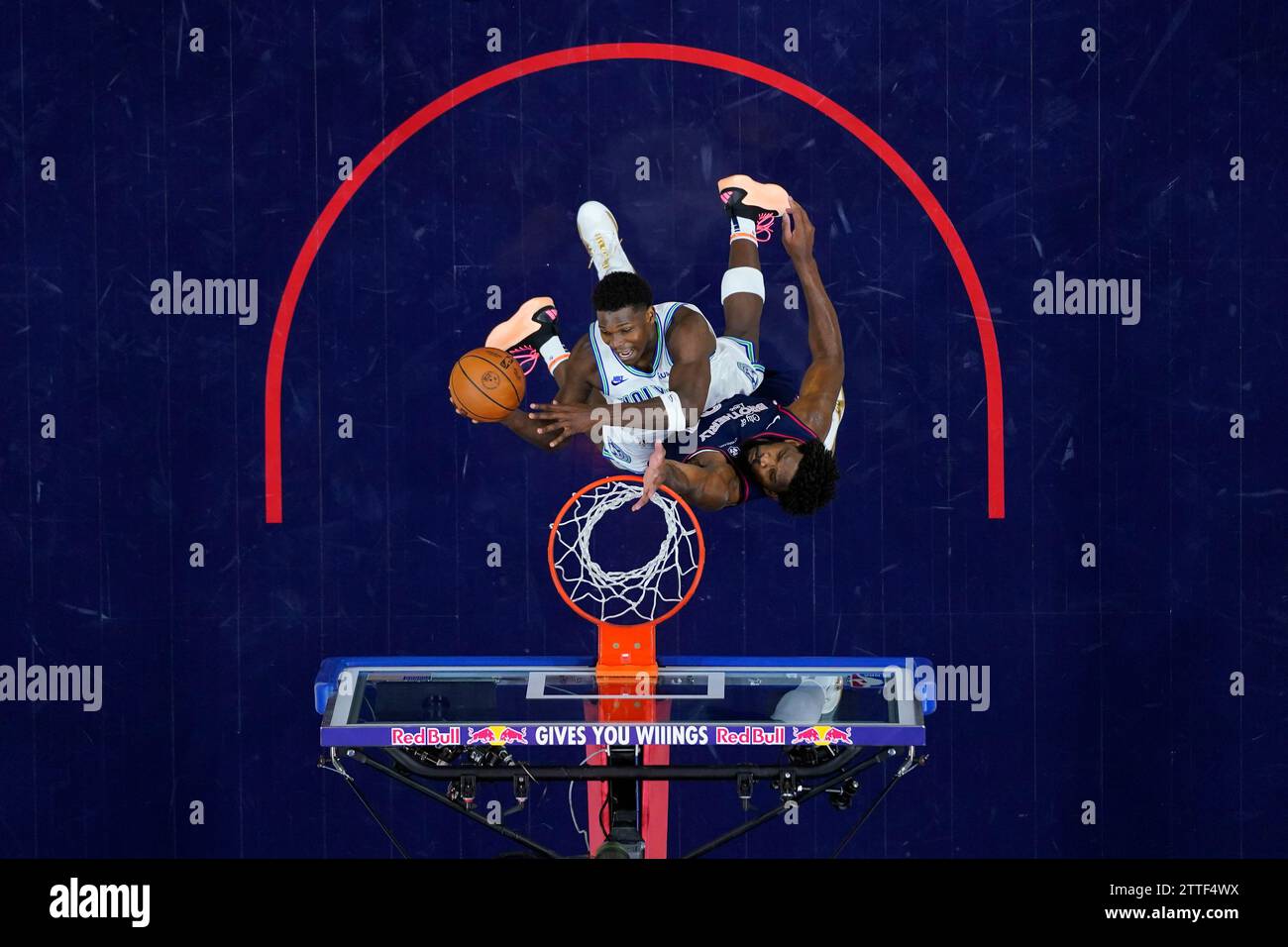 Minnesota Timberwolves' Anthony Edwards, left, goes up for a shot ...
