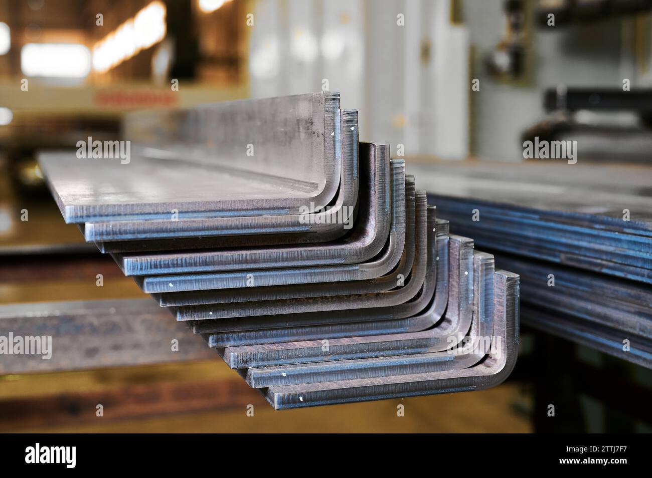 Long bent metal details stacked at production plant Stock Photo - Alamy