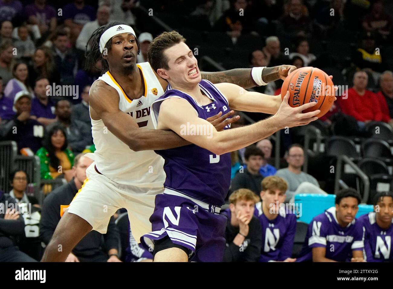 Northwestern guard Ryan Langborg (5) gets fouled by Arizona State guard Jamiya Neal during the ...