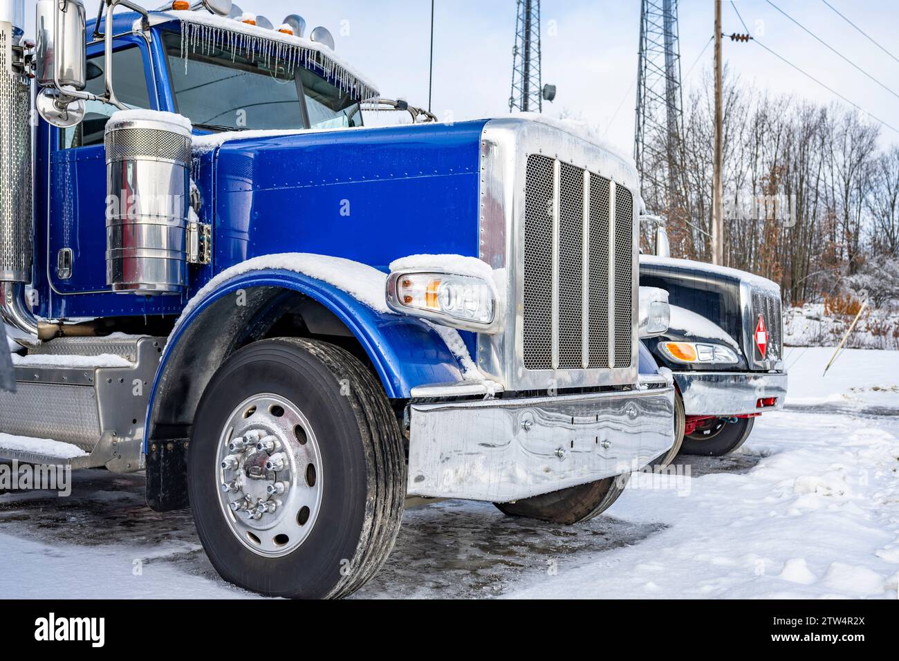 Big rig semi trucks with day cabs standing in row on the half empty ...