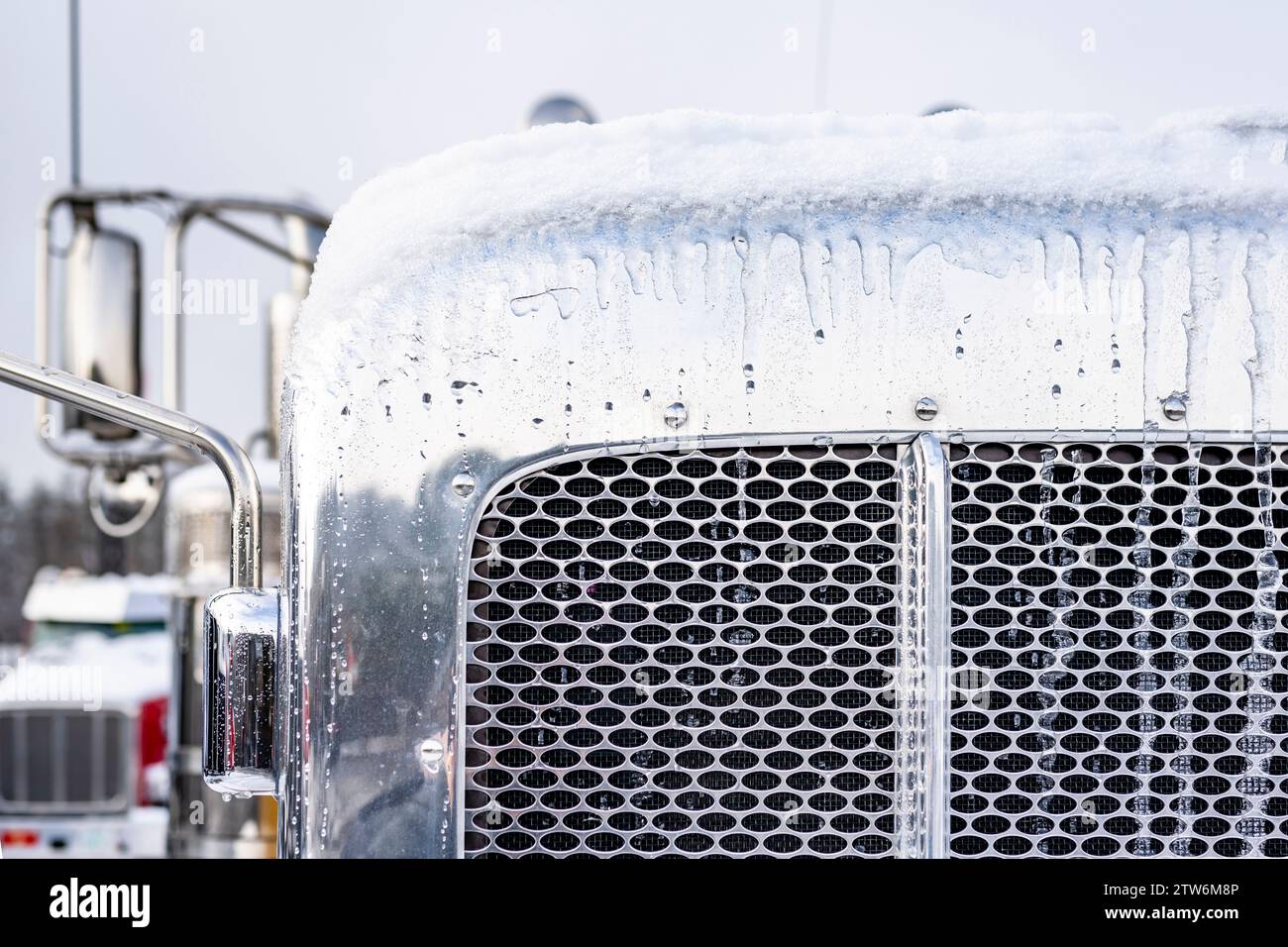 Classic big rig semi truck tractor with chrome grille covered with snow ...