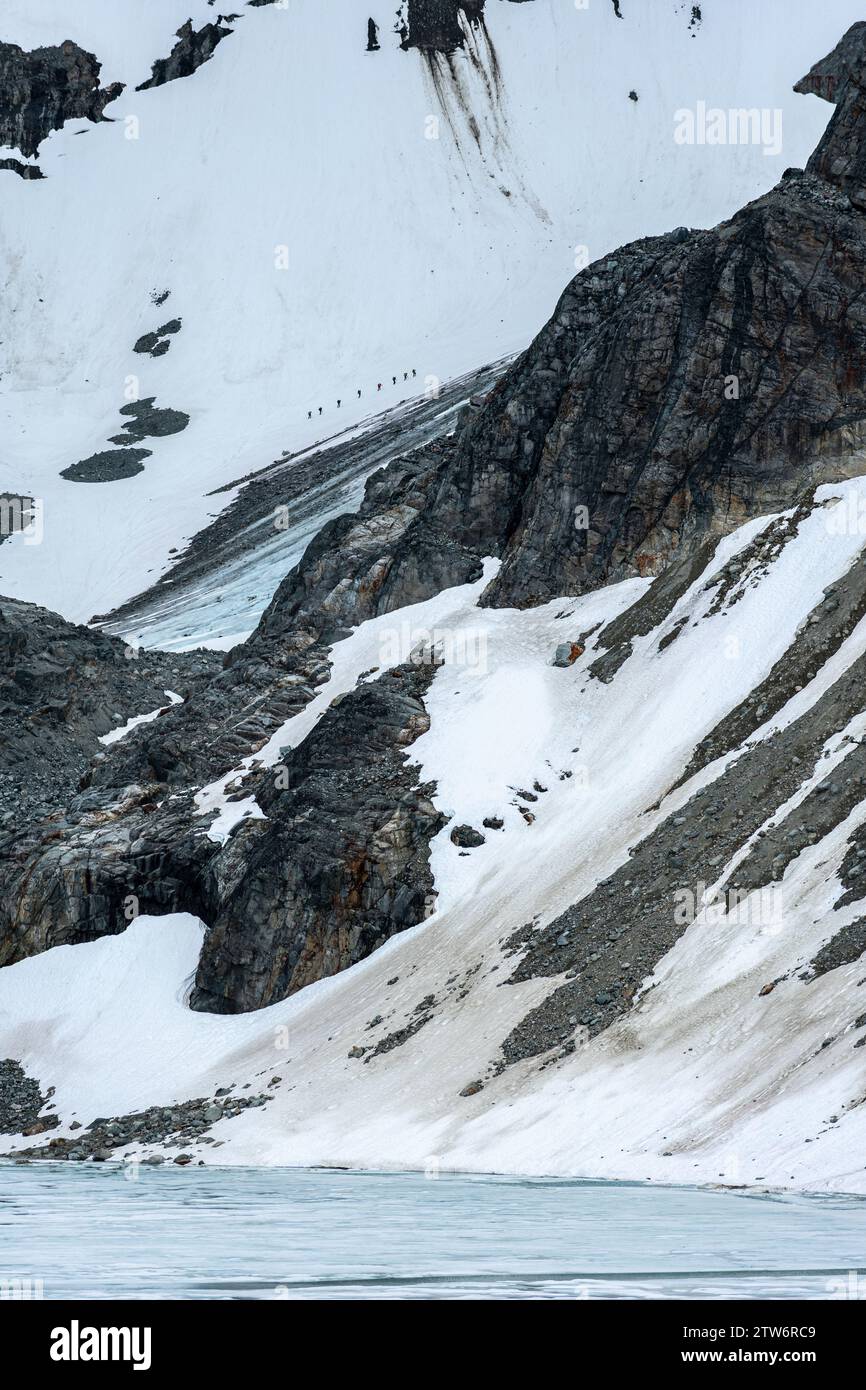 A glimpse of Wedgemount Lake's icy beauty framed by enduring mountain ...