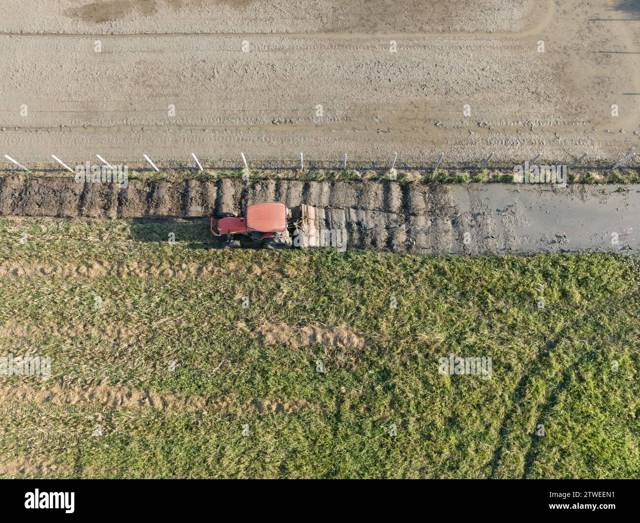 Tractor cultivating land with a rotary tiller to prepare land for next ...