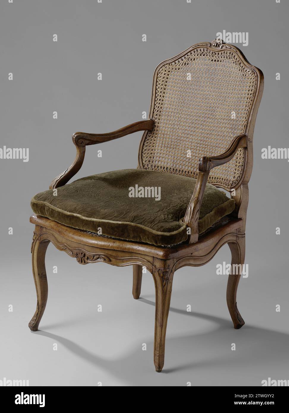 Arm chair with wicker seat and back and with a loose pillow. OVERHOUT S ...