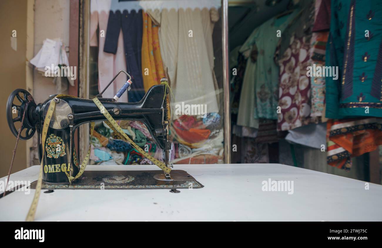 An old sewing machine on a Tailor's table Stock Photo - Alamy