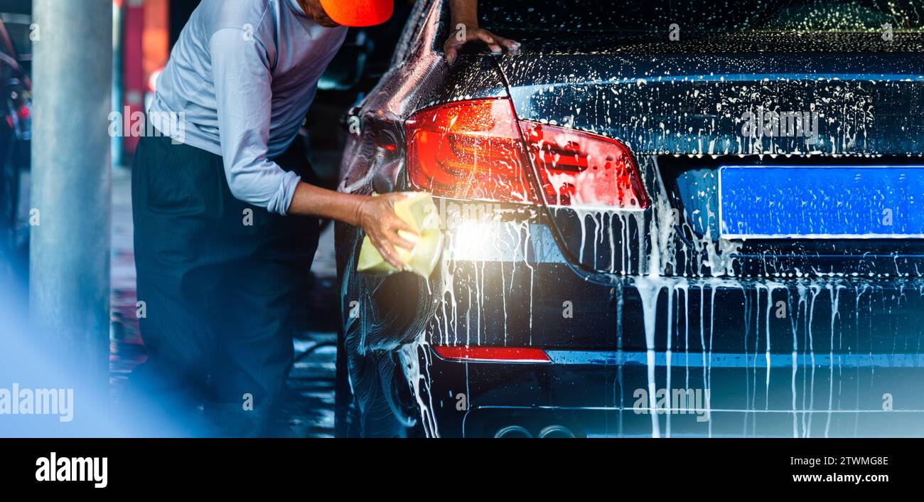 People washing car with flowing water and foam Stock Photo - Alamy