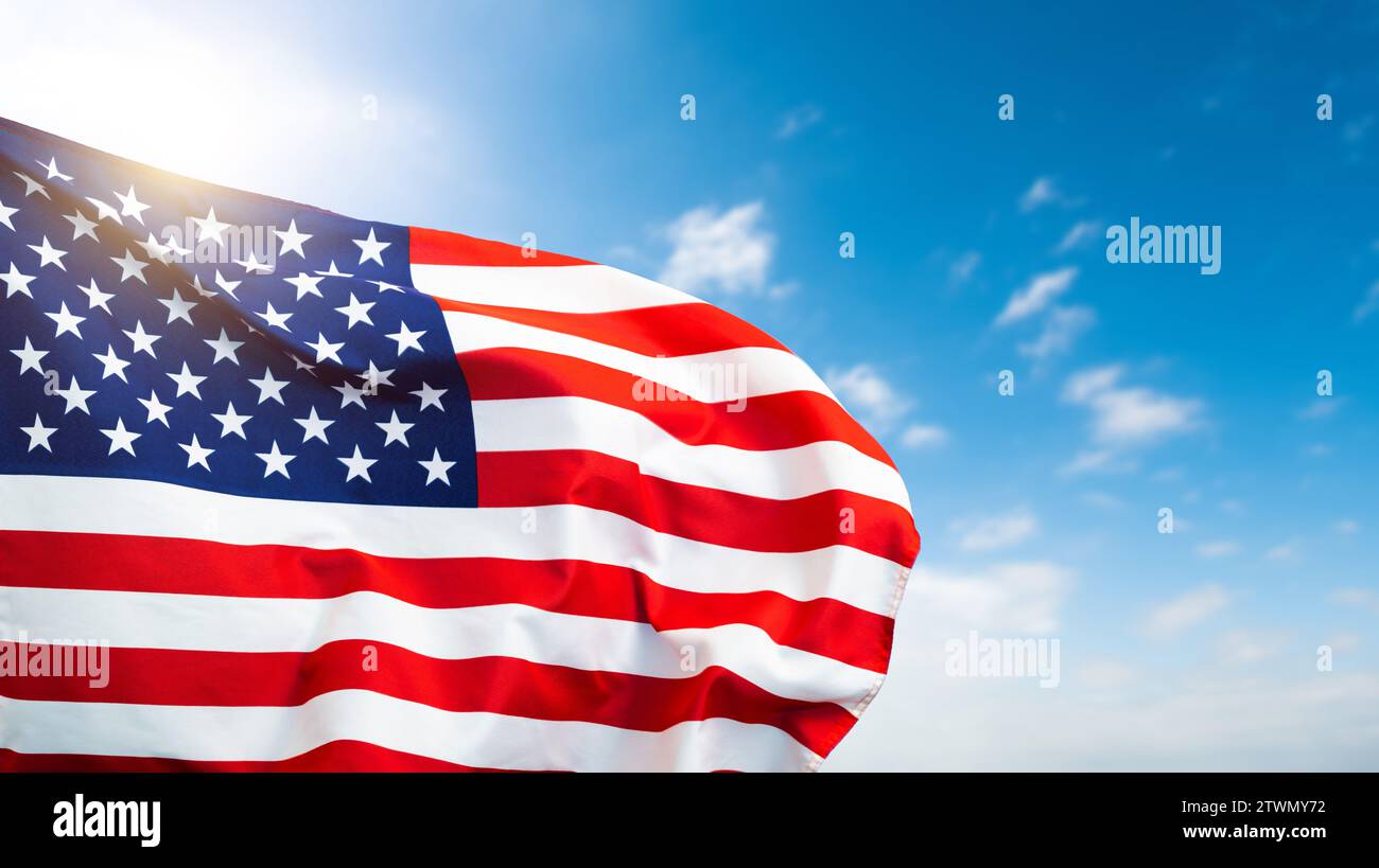 American flag waving on blue sky background Stock Photo - Alamy
