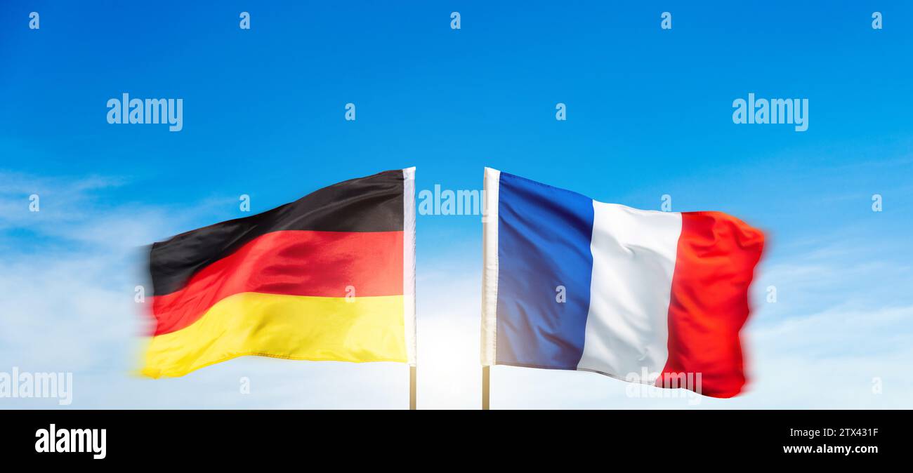 France and German flags against blue sky background Stock Photo - Alamy