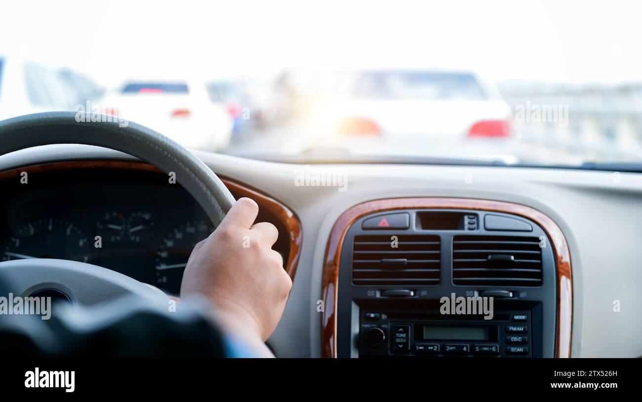 Man hand on steering wheel inside of a car at traffic jam Stock Photo ...