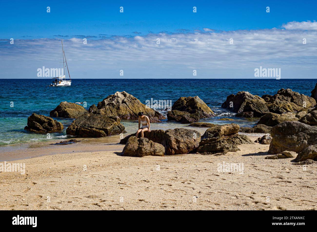 Photo of a woman on the rocks at Playa Chileno. It is one of the few ...