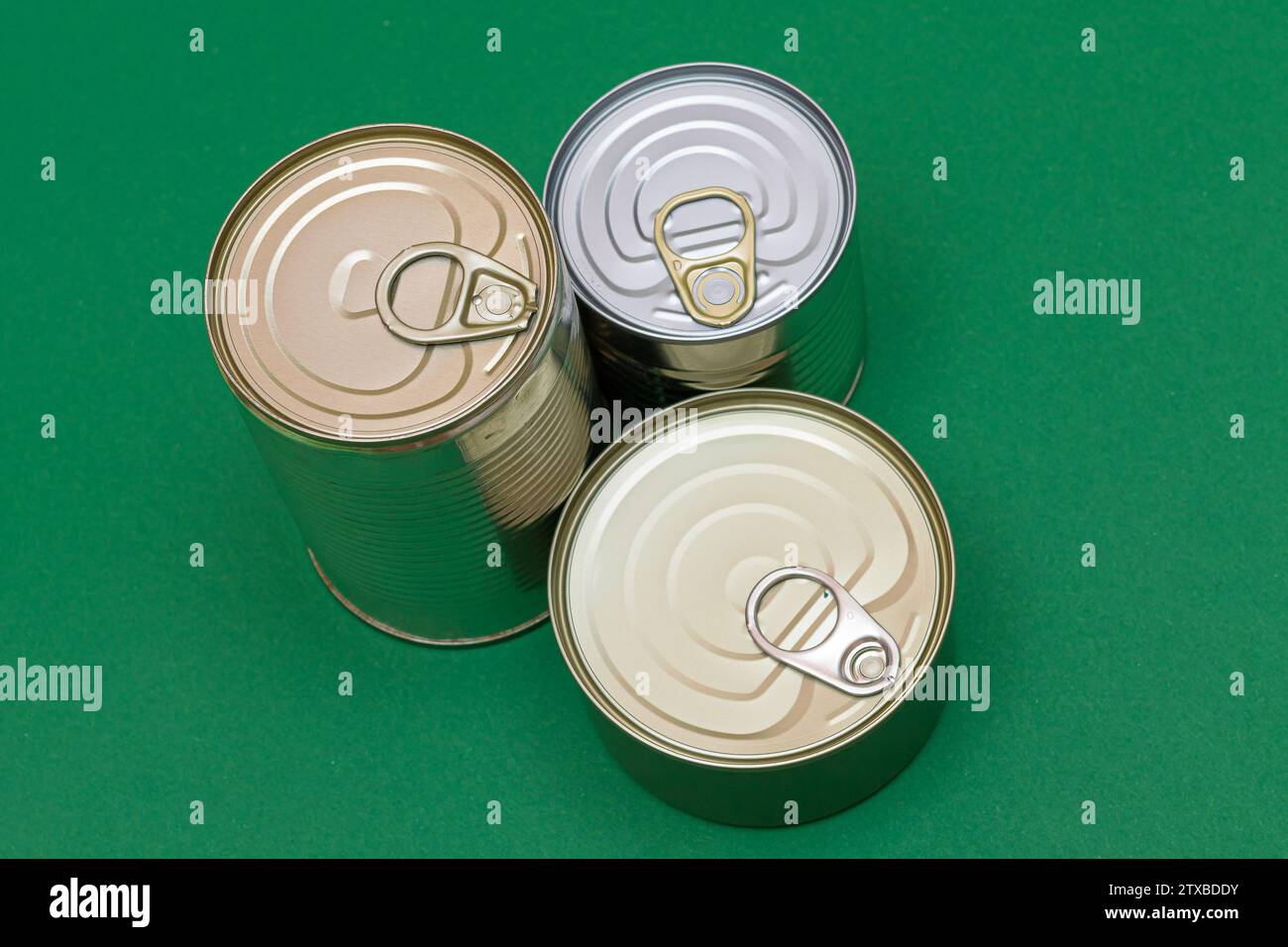 A Group of Stacked Tin Cans with Blank Edges on Green Background ...