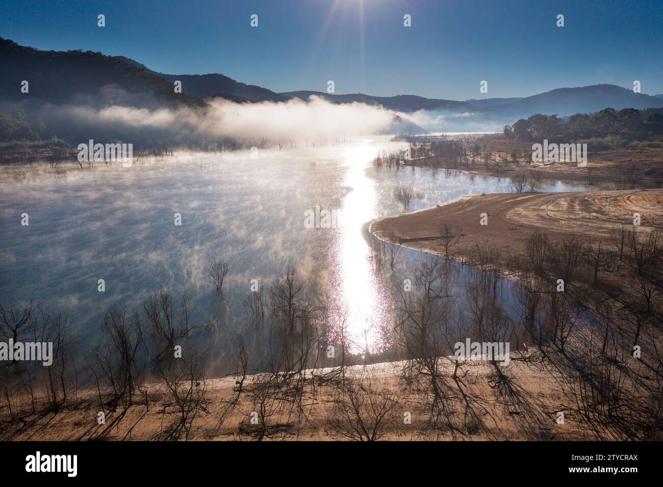 Aerial view of sunrise over a fog covered lake at Lake Eildon in the ...