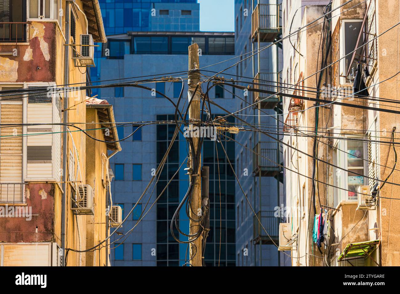 Wooden pole where a lot of street wires meet in a chaotic way Stock ...