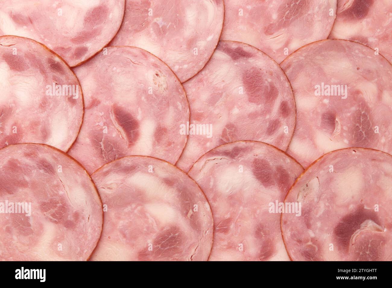 background of round pieces of ham close up, many slices of pork ham cut ...