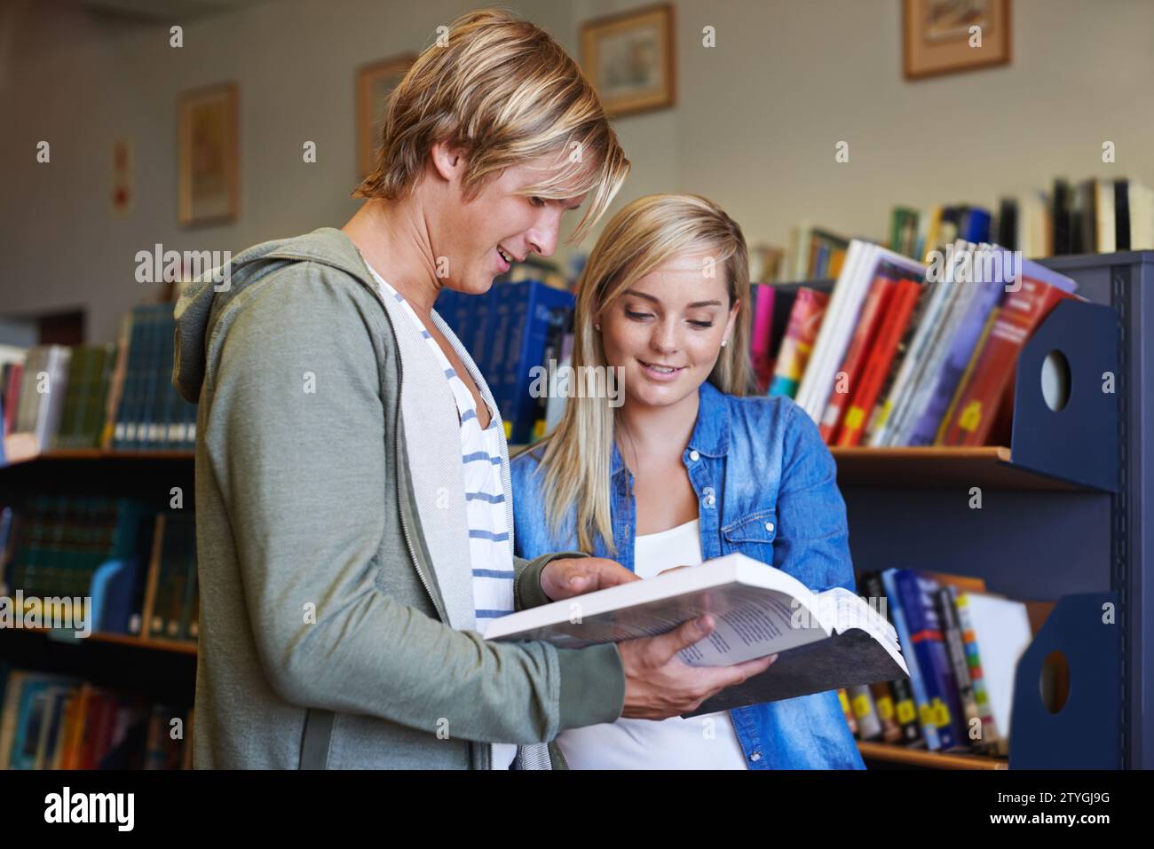 Reading book, teamwork or students in library at university, college or ...
