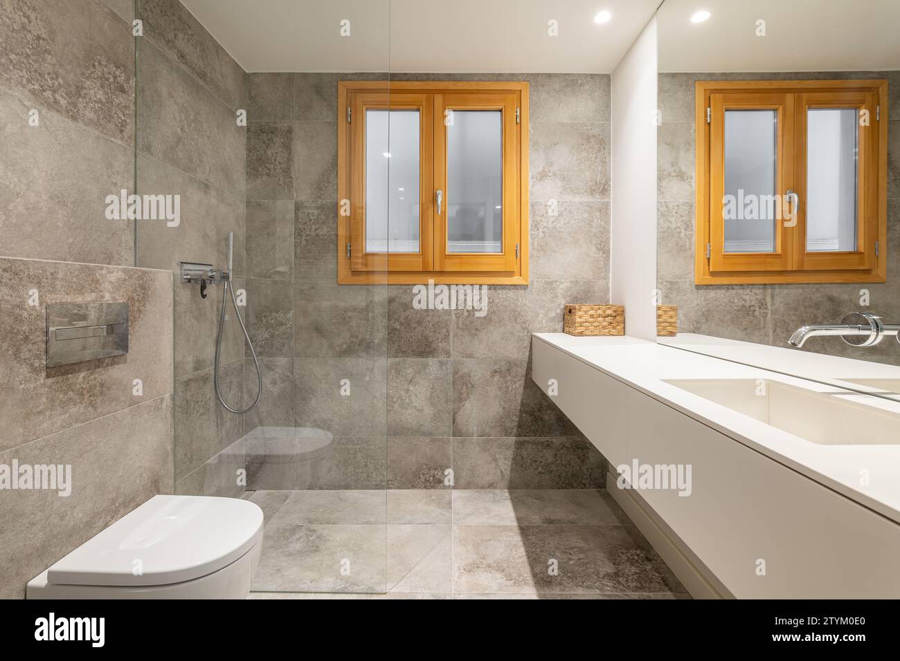 Large bathroom with long vanity unit near washbasin area Stock Photo ...