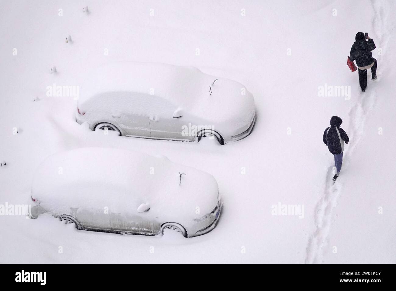 YANTAI, CHINA - DECEMBER 21, 2023 - People walk on the streets brave ...
