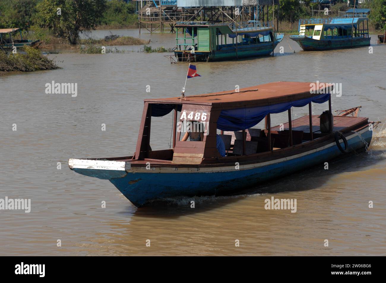 Boats moving along the waterways, Floating village Kampong Phluk in ...