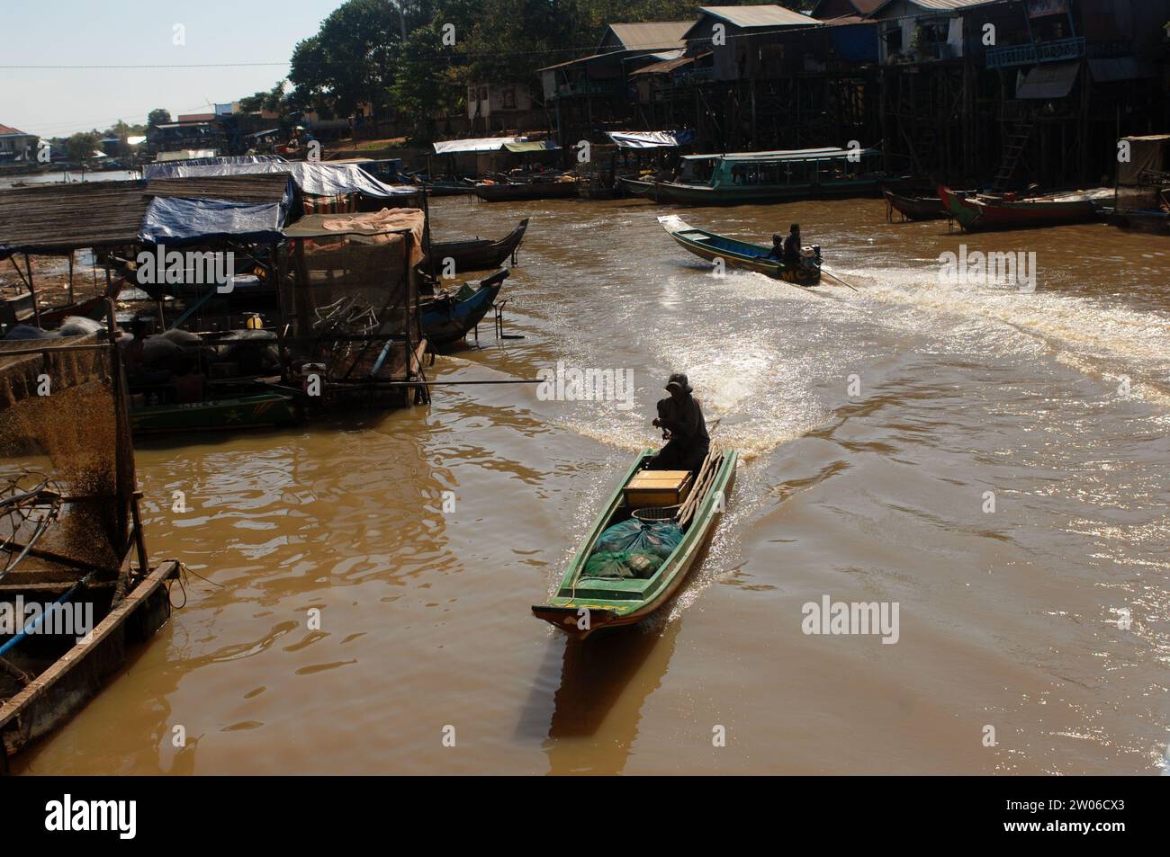 Boats moving along the waterways, Floating village Kampong Phluk in ...