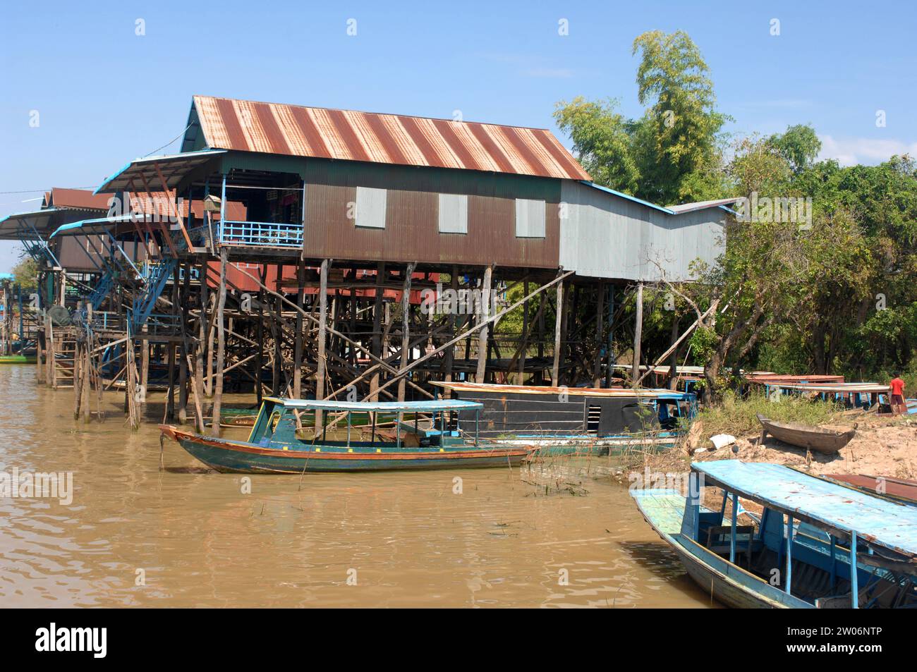 Boats moored, Lady selling food on a floating shop, Floating village ...