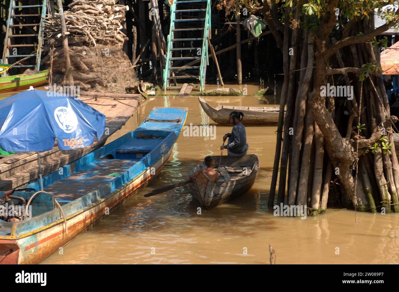 Boats moored, Lady selling food on a floating shop, Floating village ...