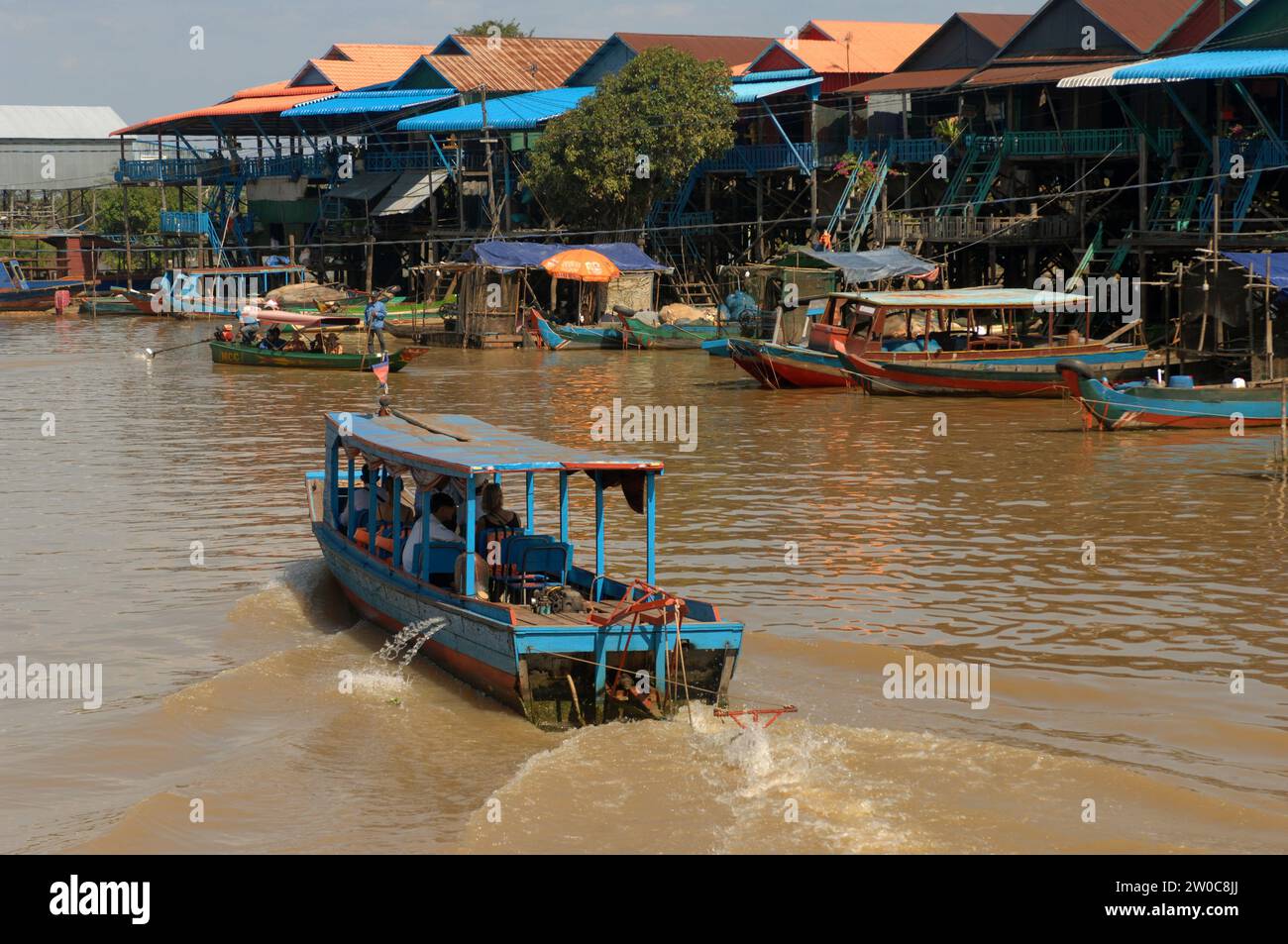 Boats moving along the waterways, Floating village Kampong Phluk in ...