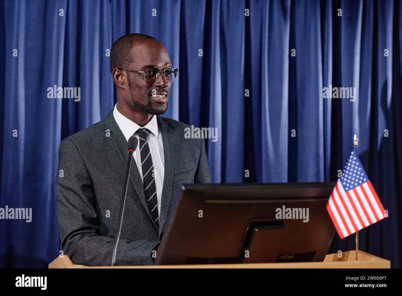African American politician in suit giving his speech at business ...