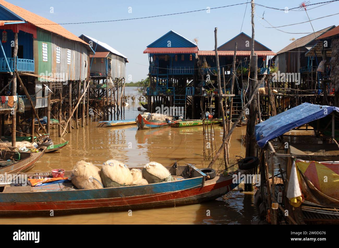 Boats moored, Lady selling food on a floating shop, Floating village ...