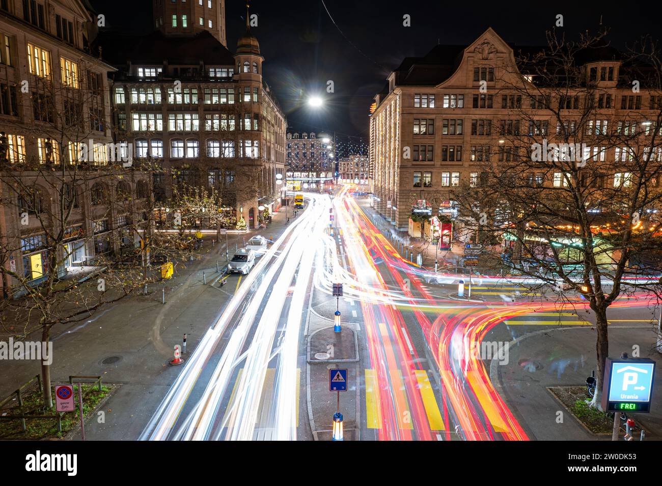 Car light streaks at busy city intersection or junction at night in a ...