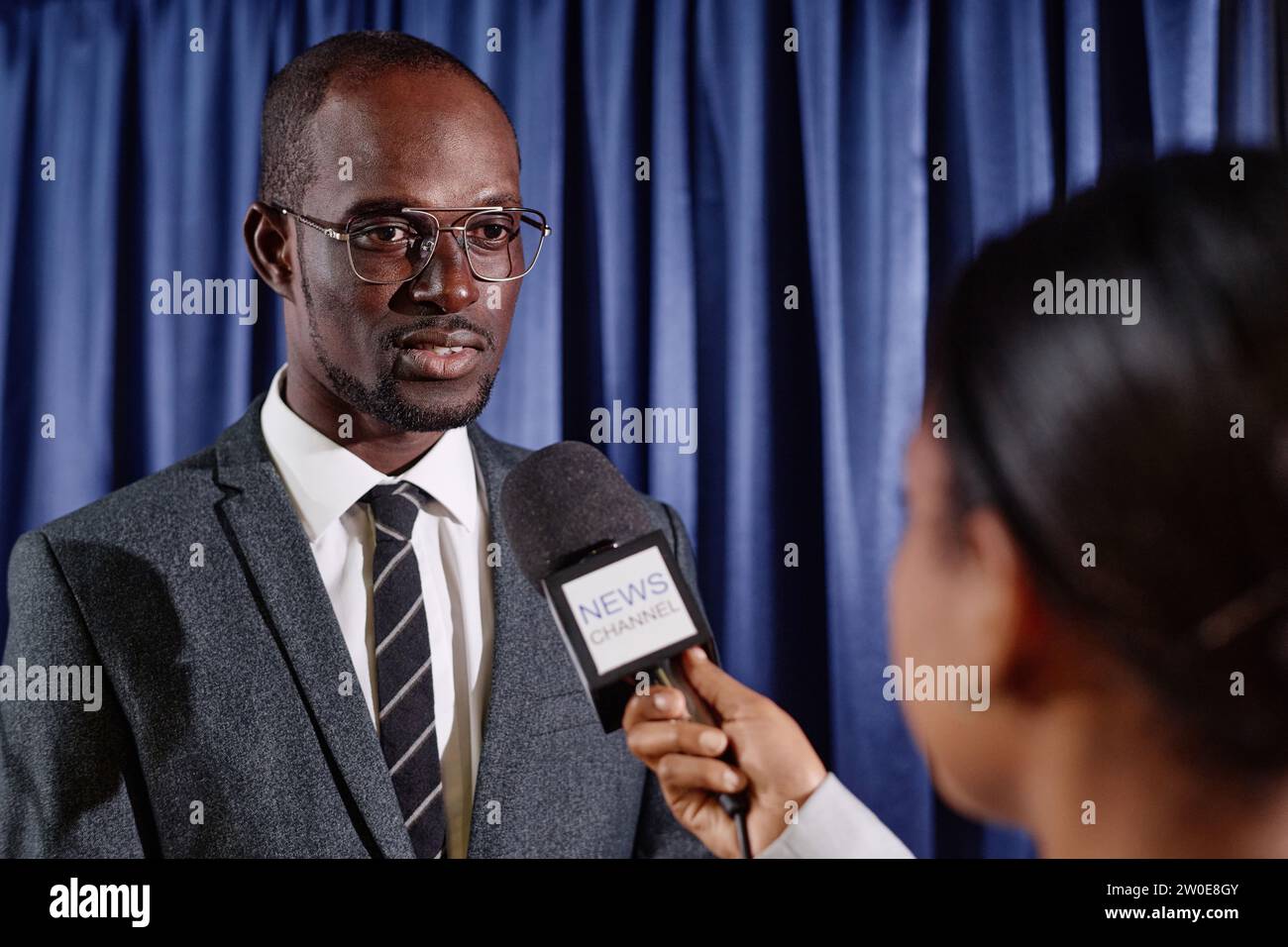 African American businessman speaking in microphone, he giving an ...