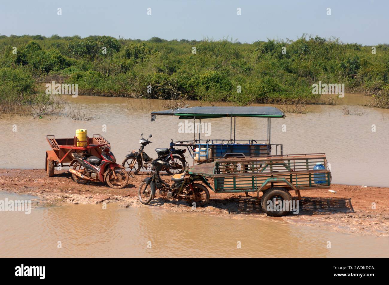 Bikes and trailers left on mudflat, Floating village Kampong Phluk in Tonle Sap Lake, Cambodia ...