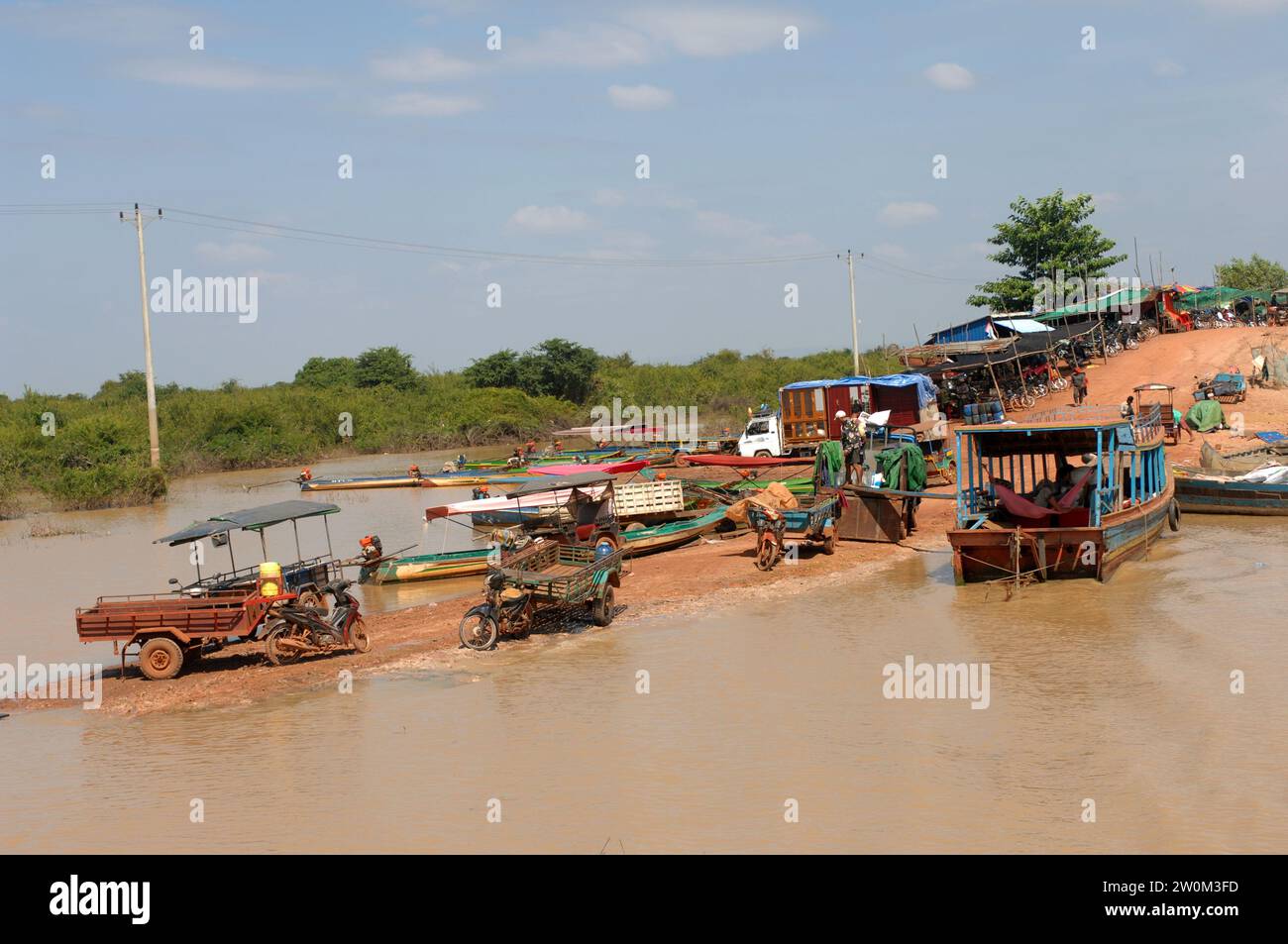 Bikes and trailers left on mudflat, Floating village Kampong Phluk in Tonle Sap Lake, Cambodia ...