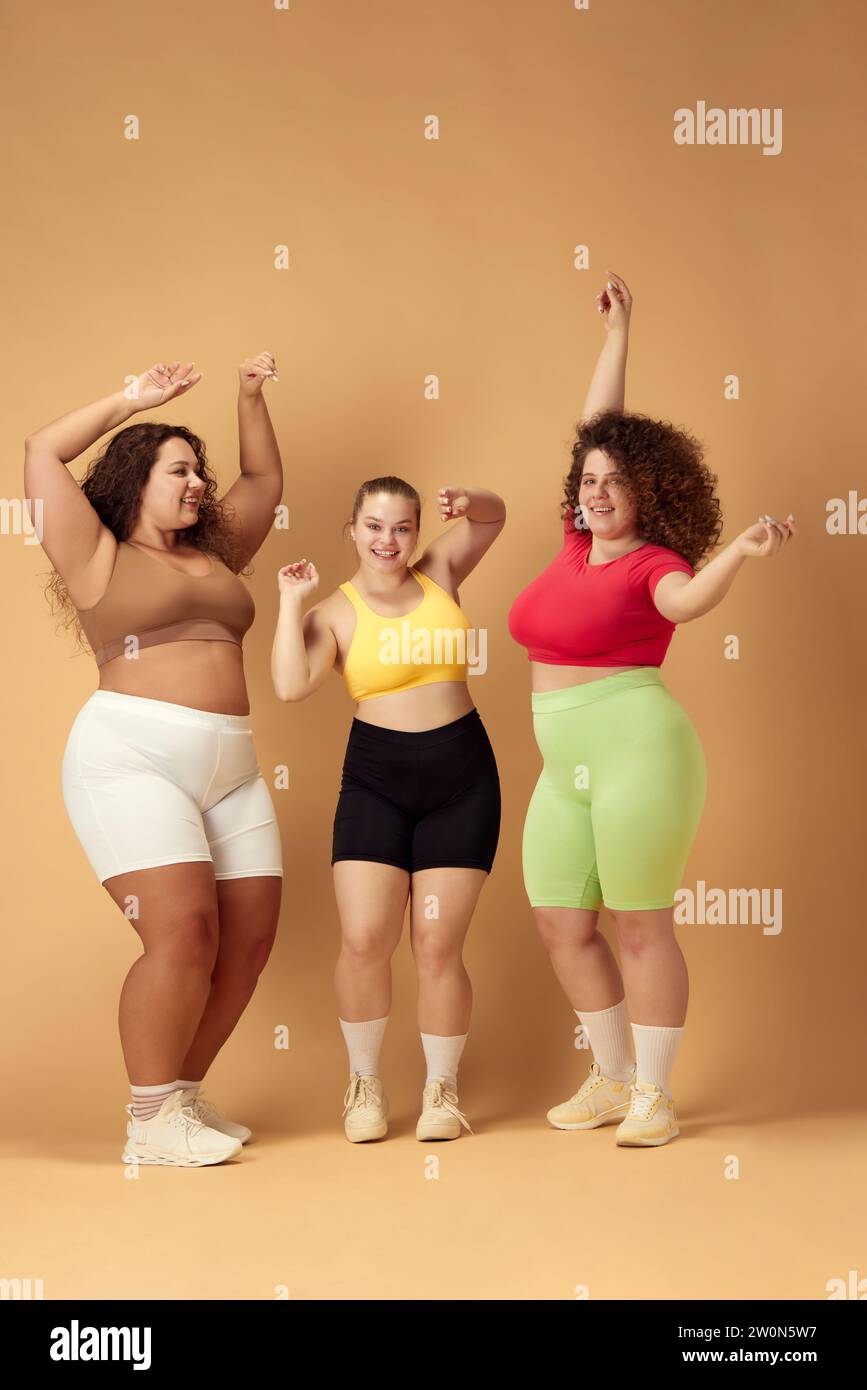 Full-length image of three beautiful women with fat, overweigh bodies ...