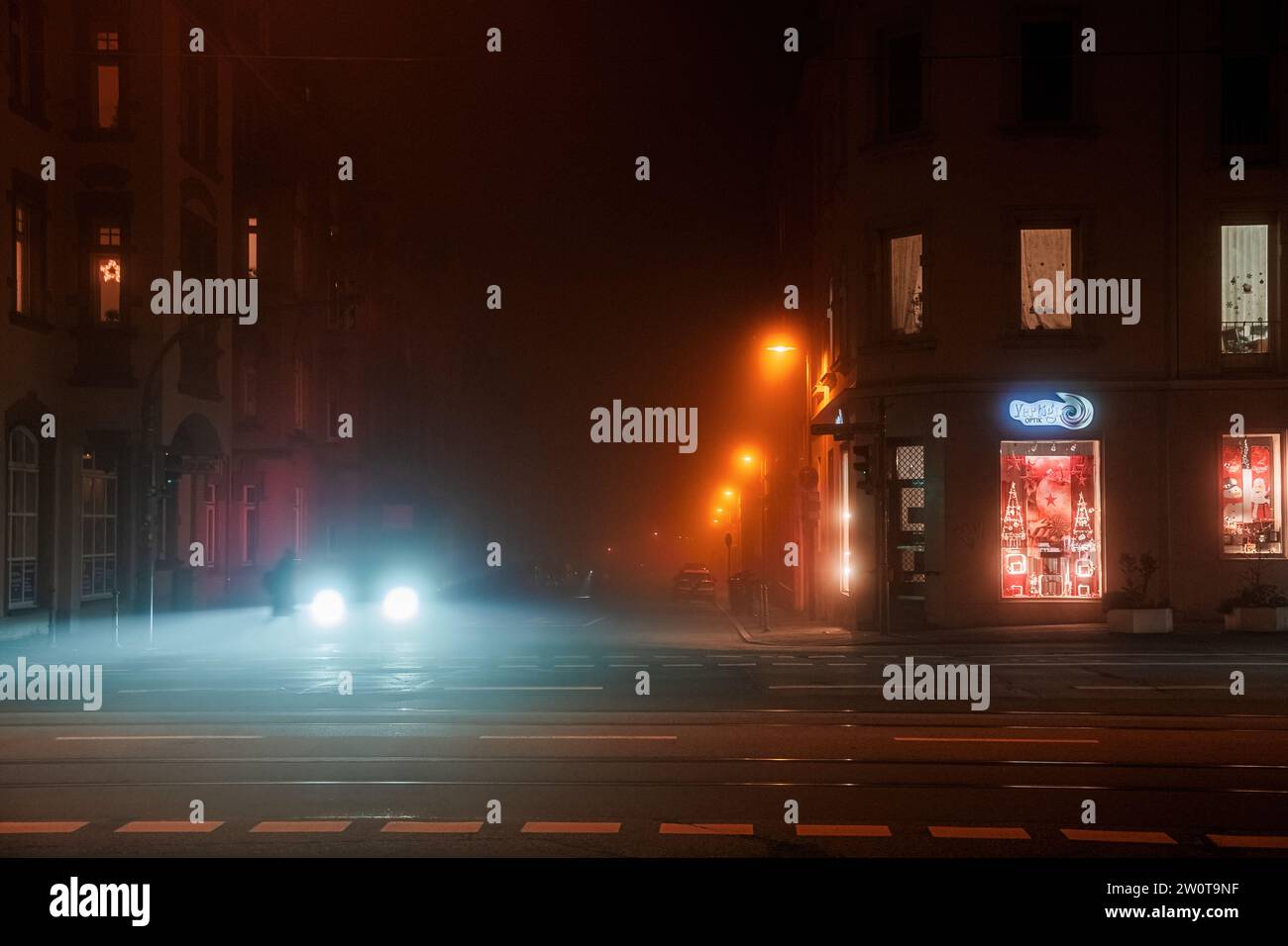 foggy street corner at night with street lights in Germany, Europe ...