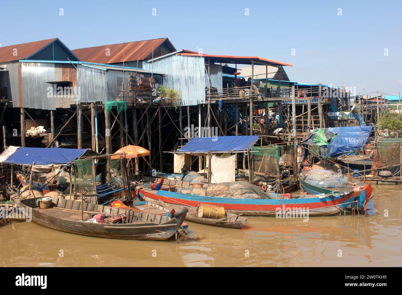 Boats moored, Lady selling food on a floating shop, Floating village ...
