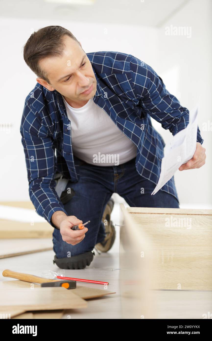 professional furniture assembly worker assembles shelf Stock Photo - Alamy