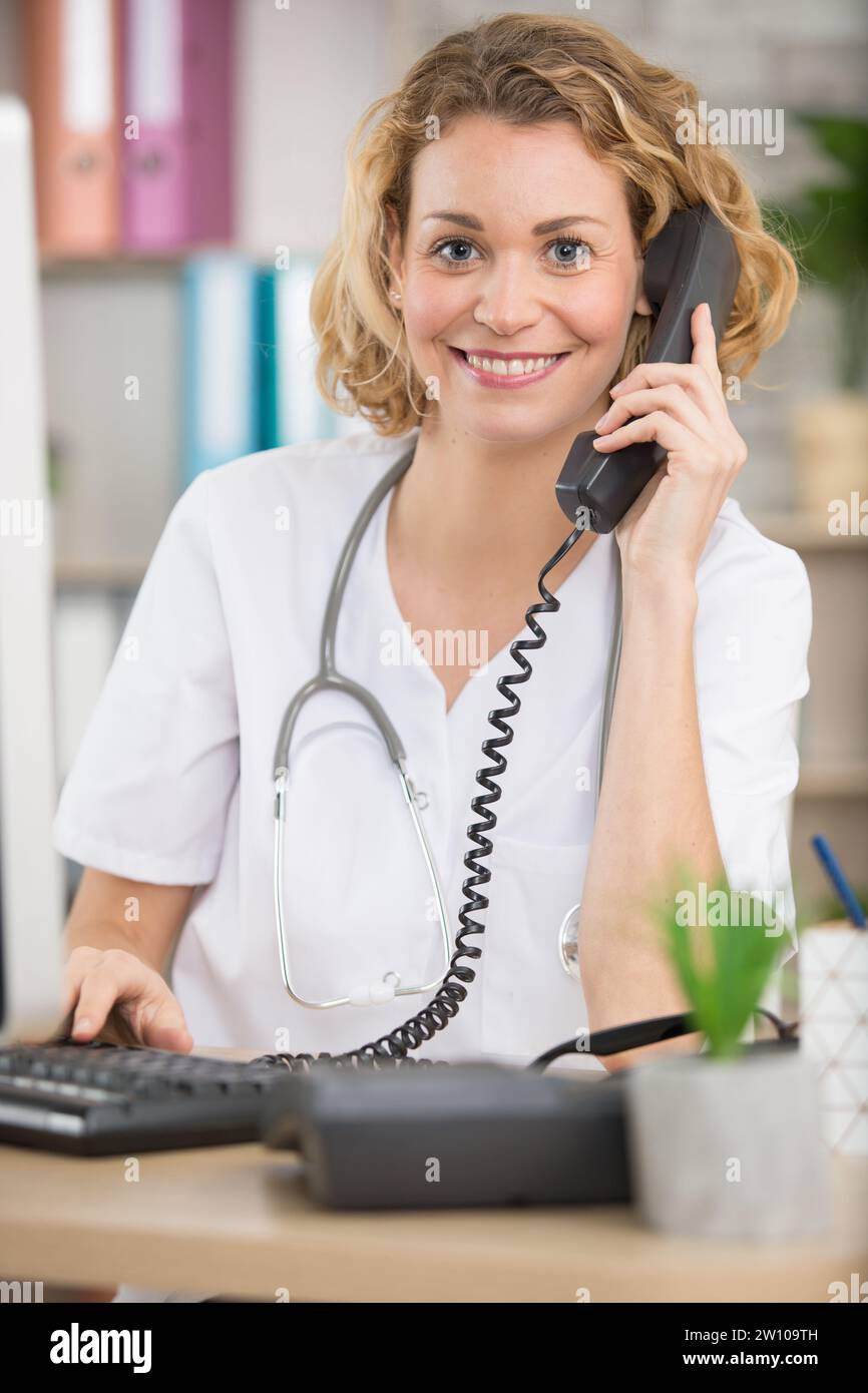 female doctor talking on the surgery telephone Stock Photo - Alamy