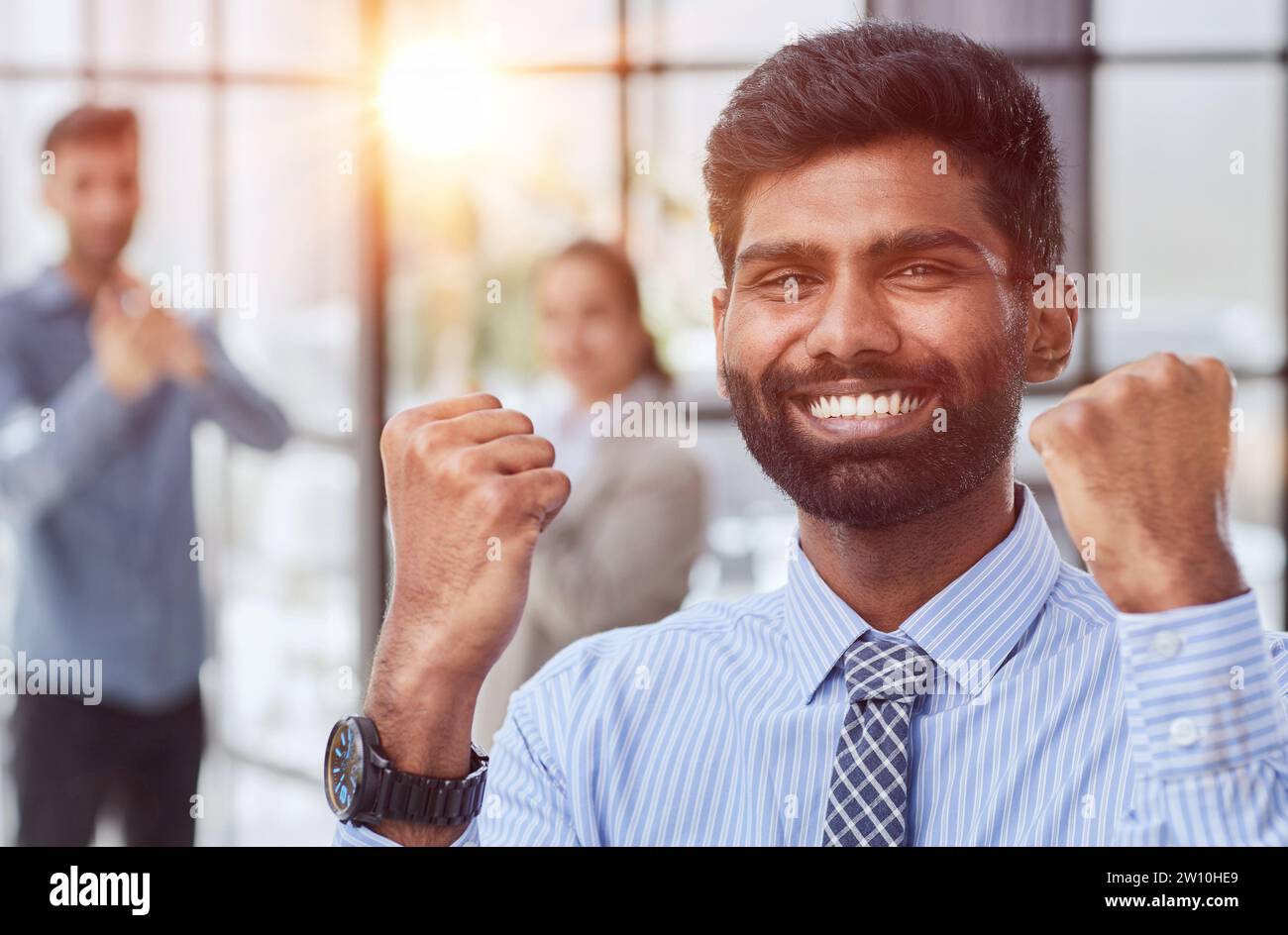 a man holding his hand up a gesture of triumph and victory Stock Photo ...
